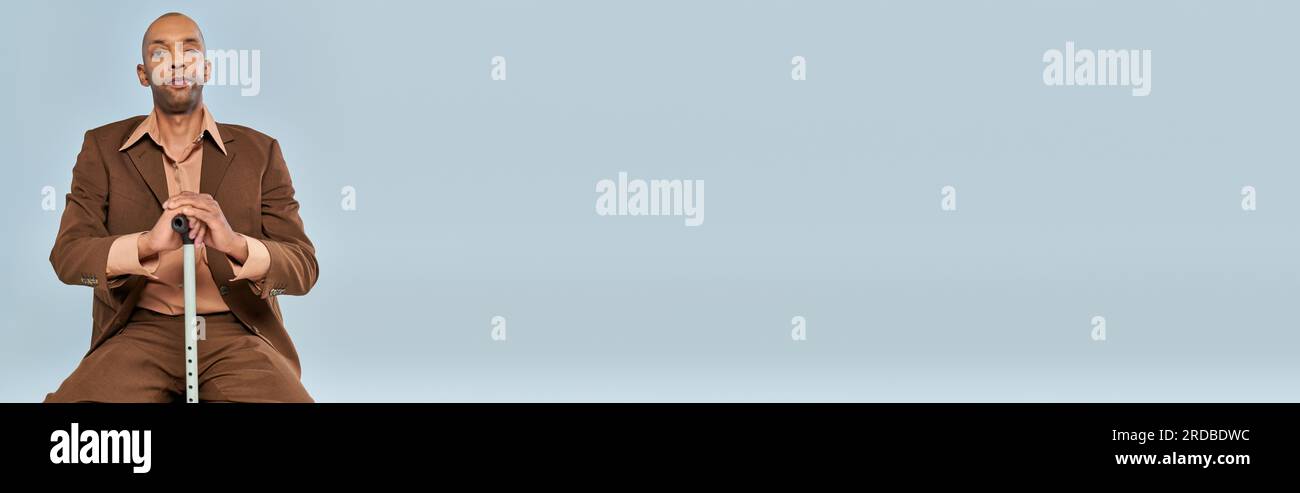 disability, bold african american man with myasthenia gravis sitting on ...