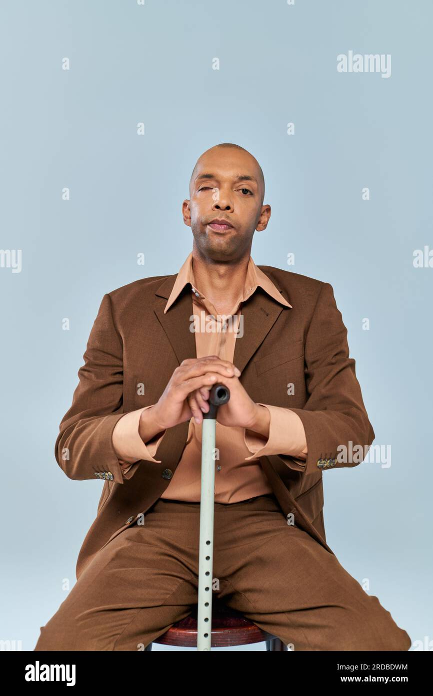 disability, bold african american man with myasthenia gravis sitting on ...