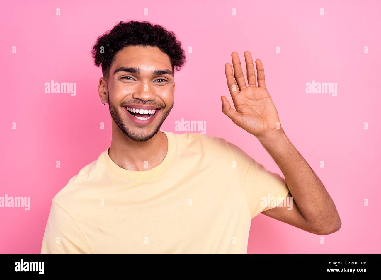 Photo of funny guy toothy smiling raise hand waving his friends say hi ...