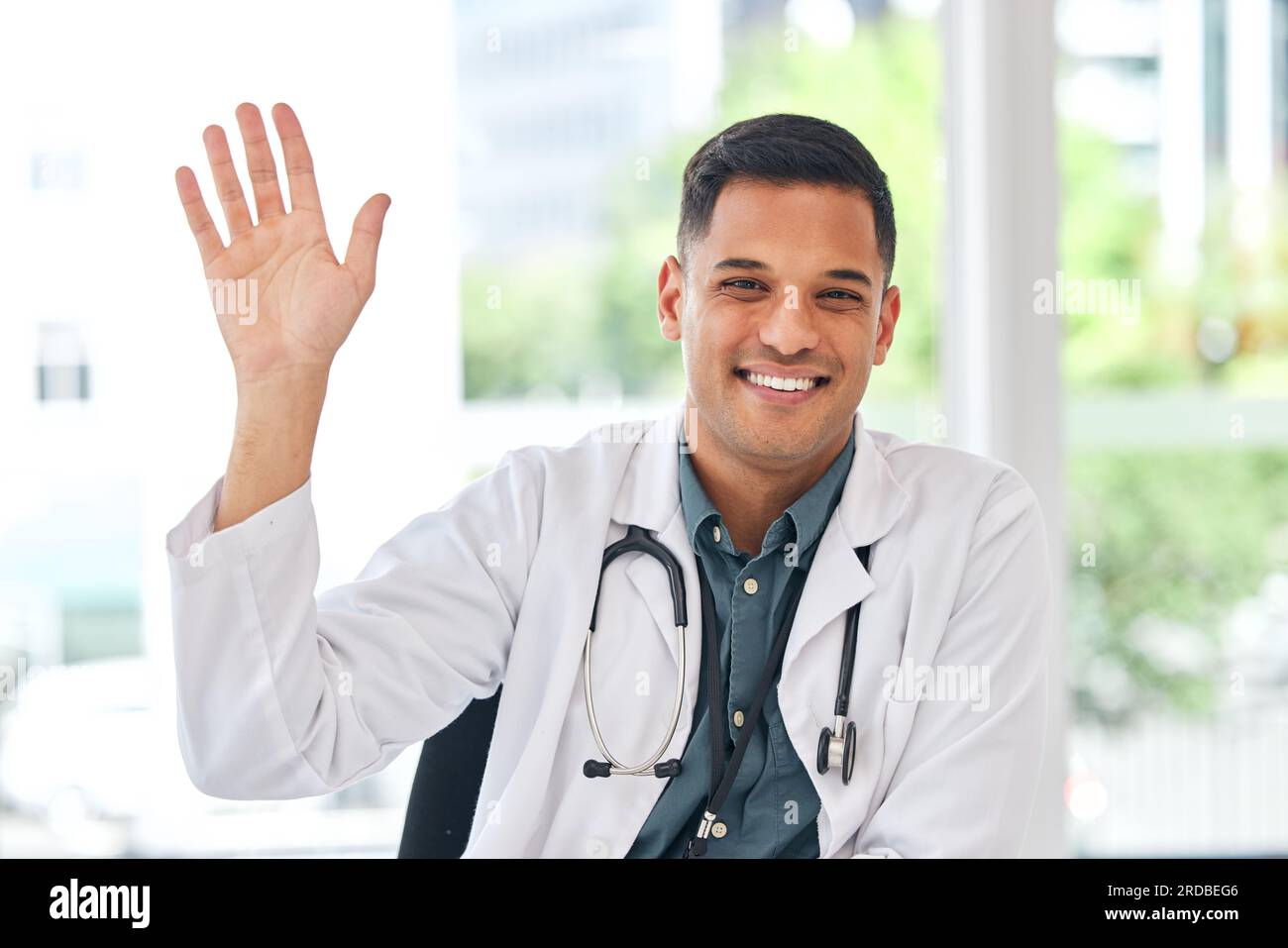 Doctor, portrait and wave with smile at desk for video call, telehealth ...