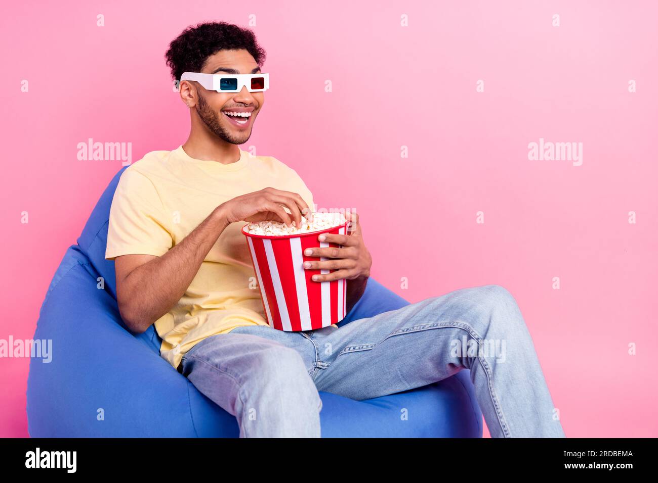 Photo of young surprised guy hold bucket popcorn snacks eating ...
