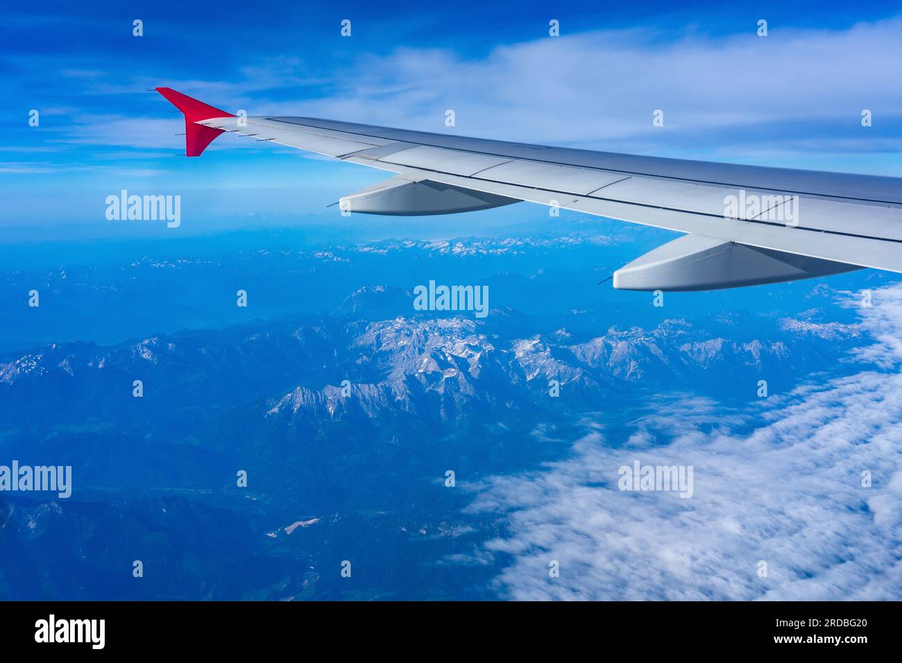 misty mountain peaks from the airplane flying above the alps with plane ...