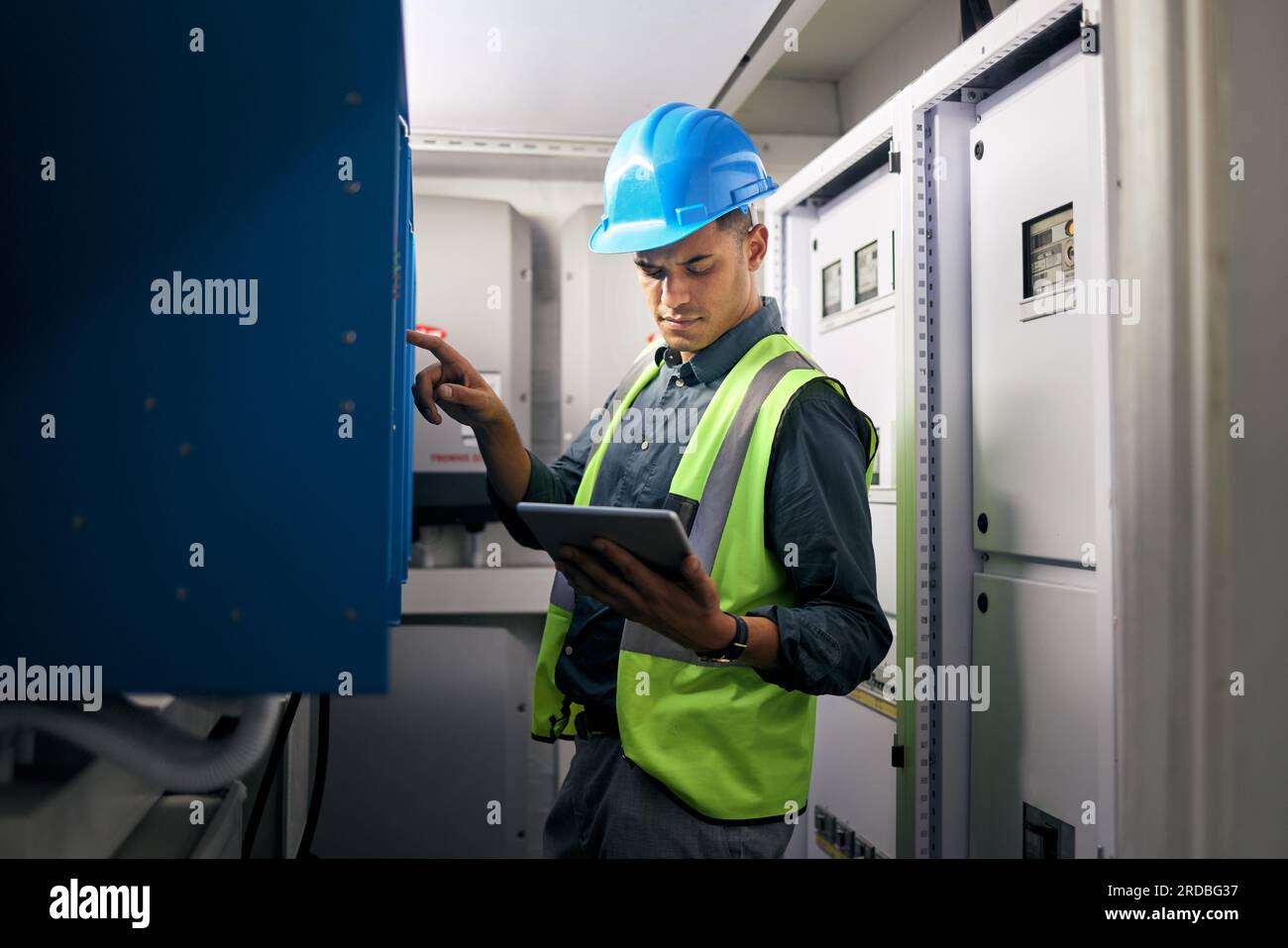 Electrician, tablet and technician with man in control room for ...