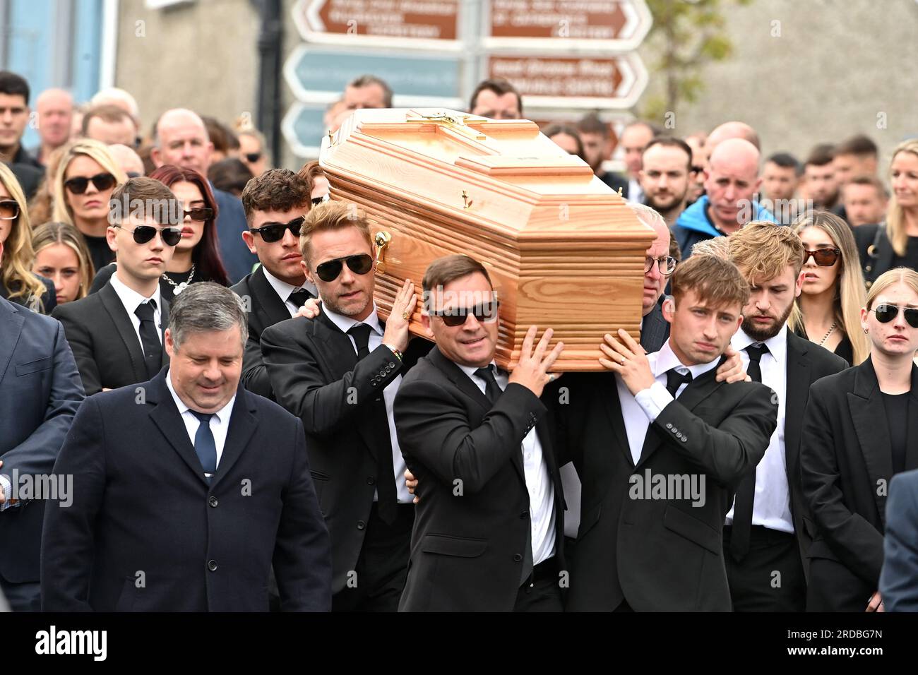 Ronan Keating (centre middle left) helps carry the coffin of his ...