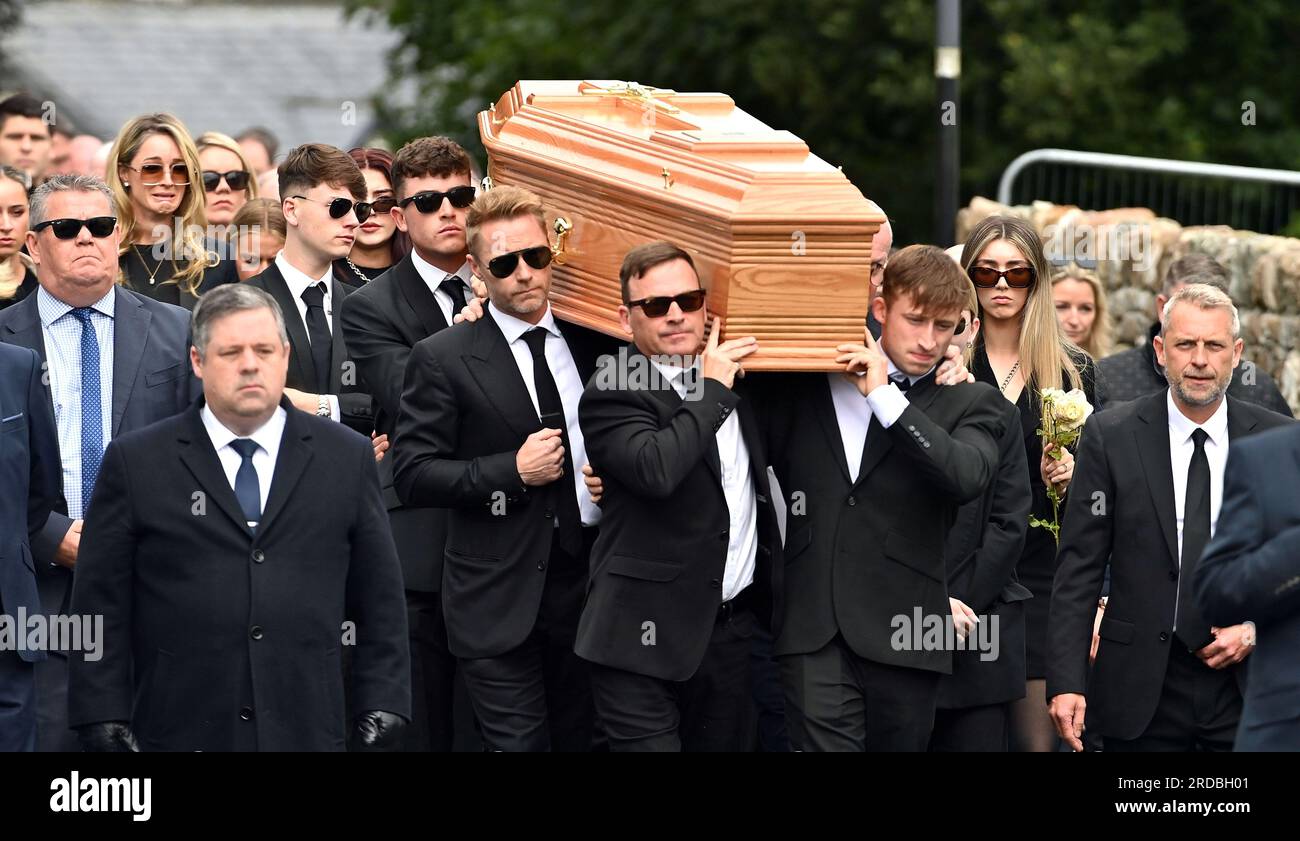 Ronan Keating (centre middle left) helps carry the coffin of his ...