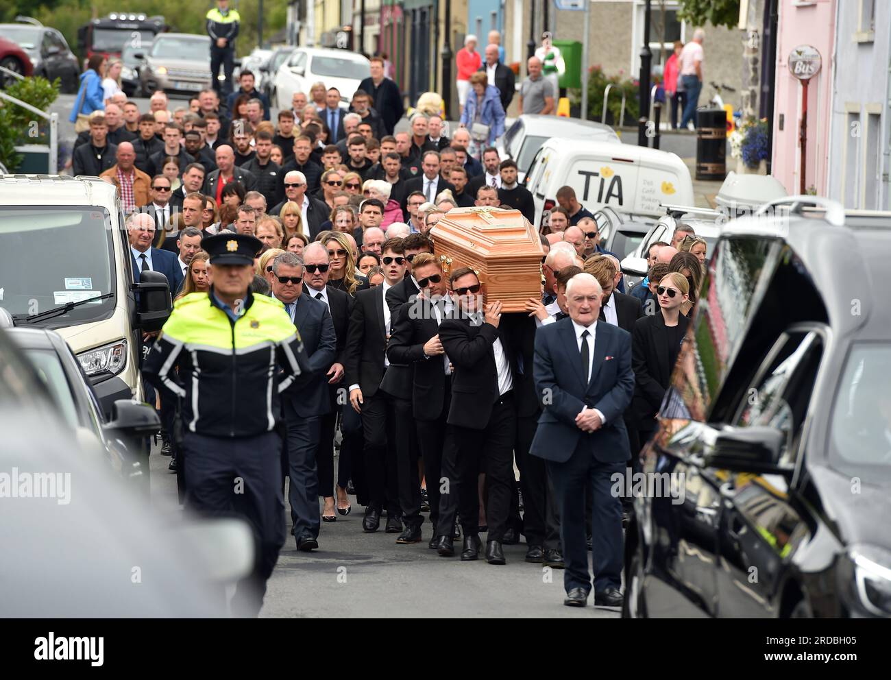 Ronan Keating (centre middle left) helps carry the coffin of his ...