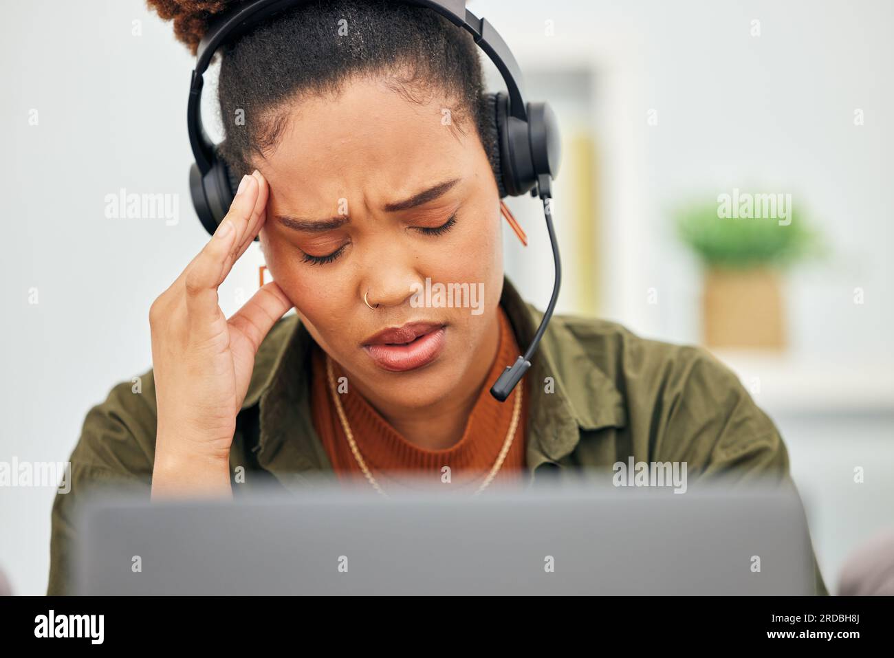Stress, call center and headache of woman at laptop in customer service ...