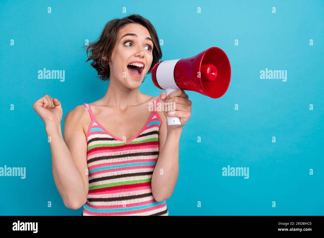 Photo of funky lucky lady wear striped singlet rising fist yelling ...