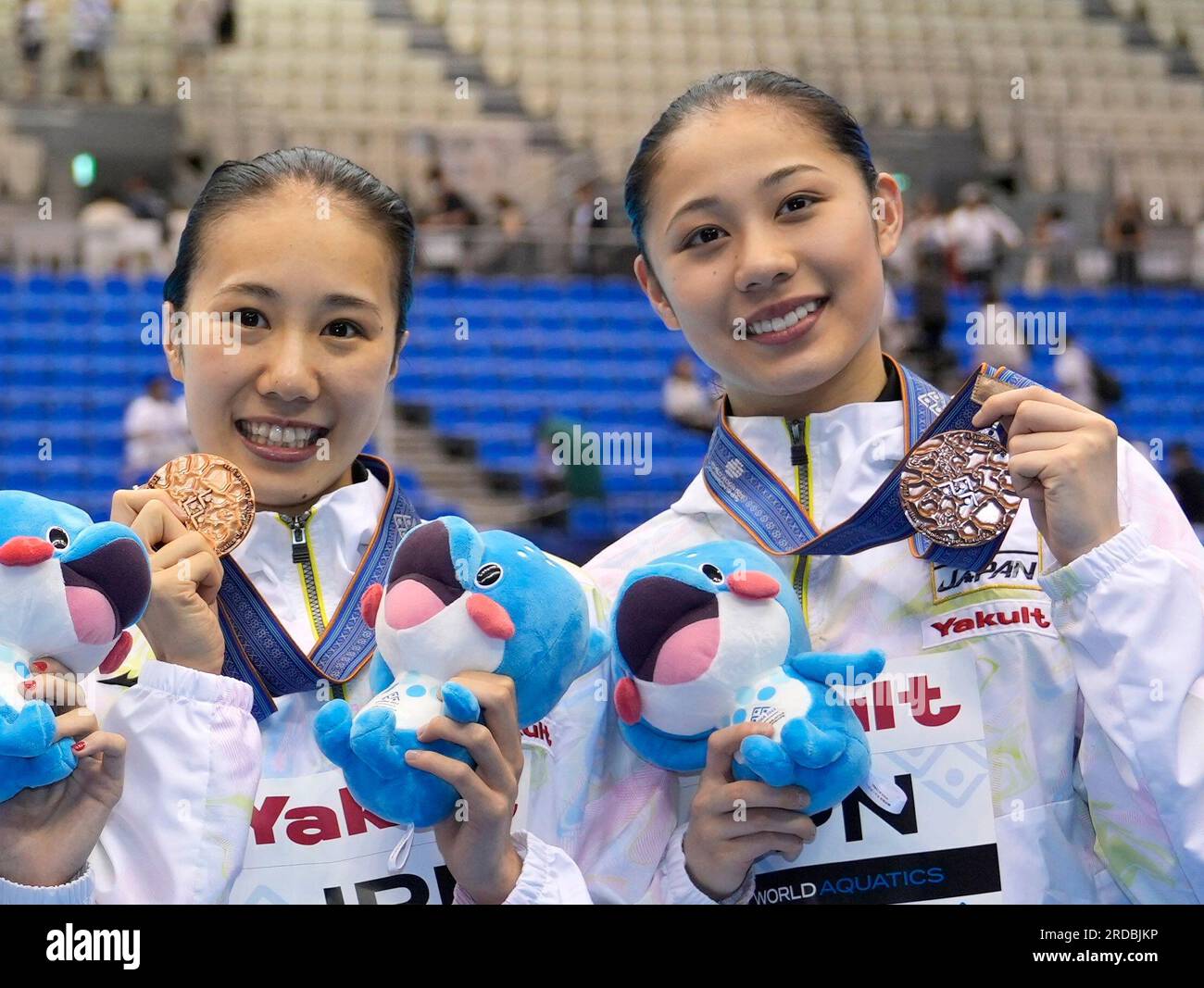 The duet of Mashiro Yasunaga and Moe Higa, of Japan, hold up their ...