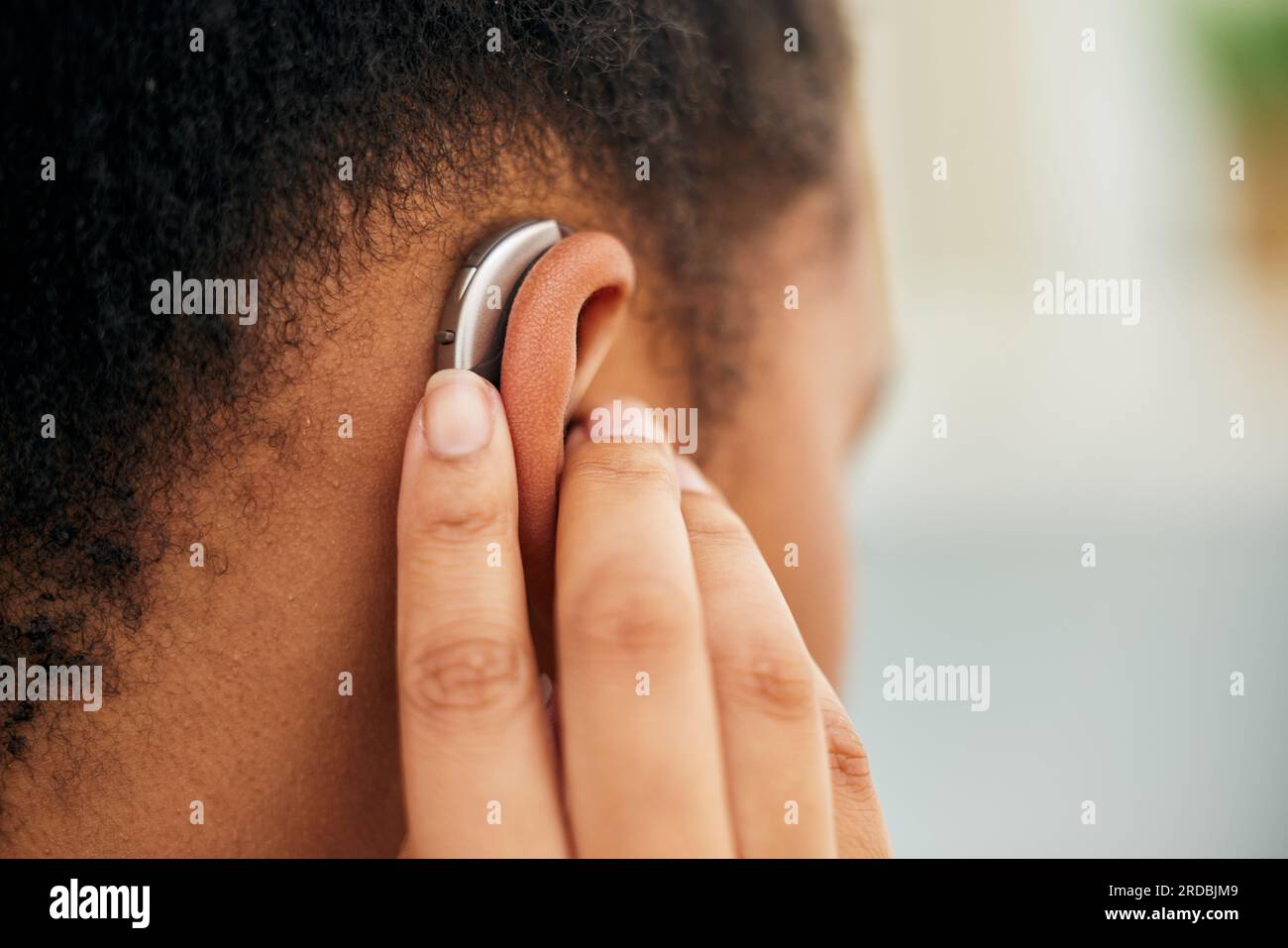 Closeup of ear, hearing aid and person disability from the back for ...