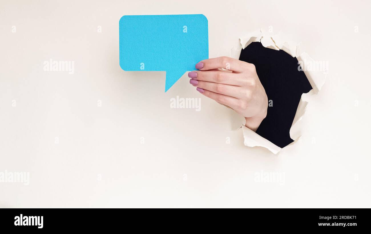 Online chat icon. Blank speech bubble. Female hand inside breakthrough paper black hole showing ...
