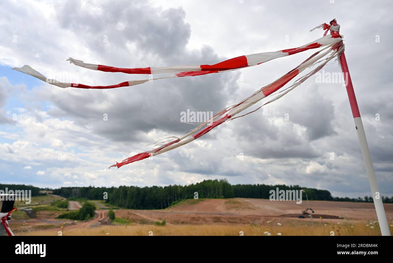 20 July 2023, Thuringia, Zwirtzschen: Barrier tapes wave during the ...