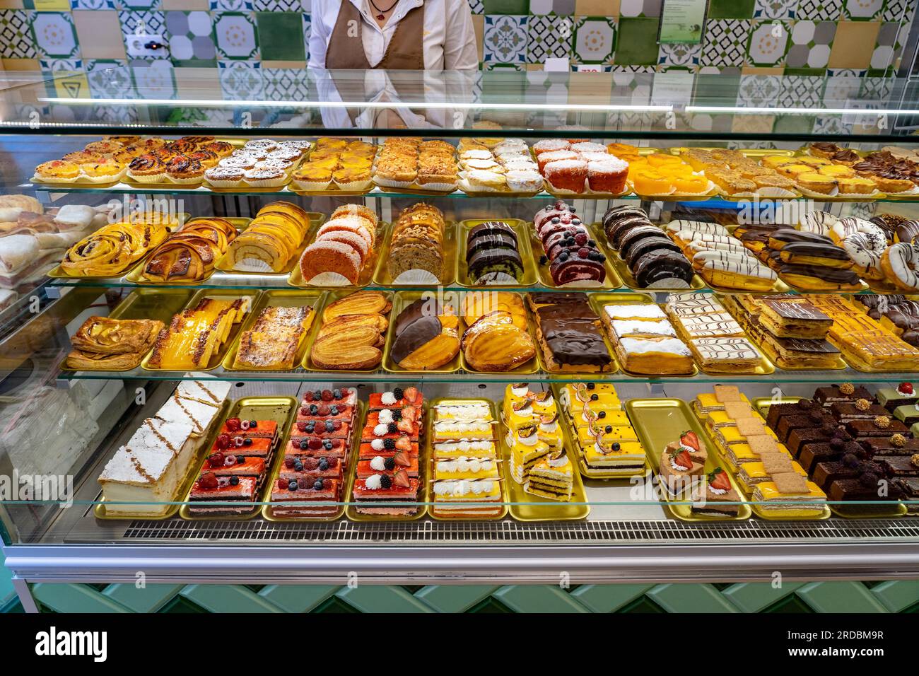 confectionery bakery variety of traditional colorful cakes in a counter ...