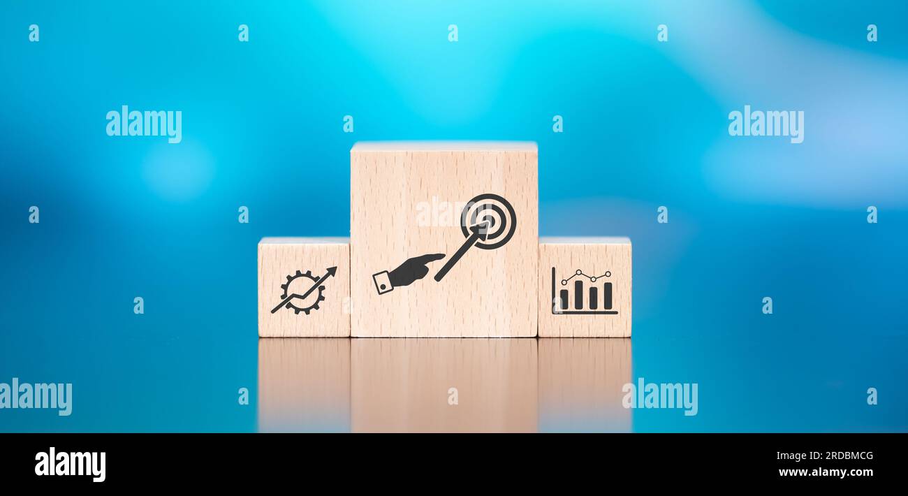 Wooden blocks with symbol of motivation concept on blue background ...