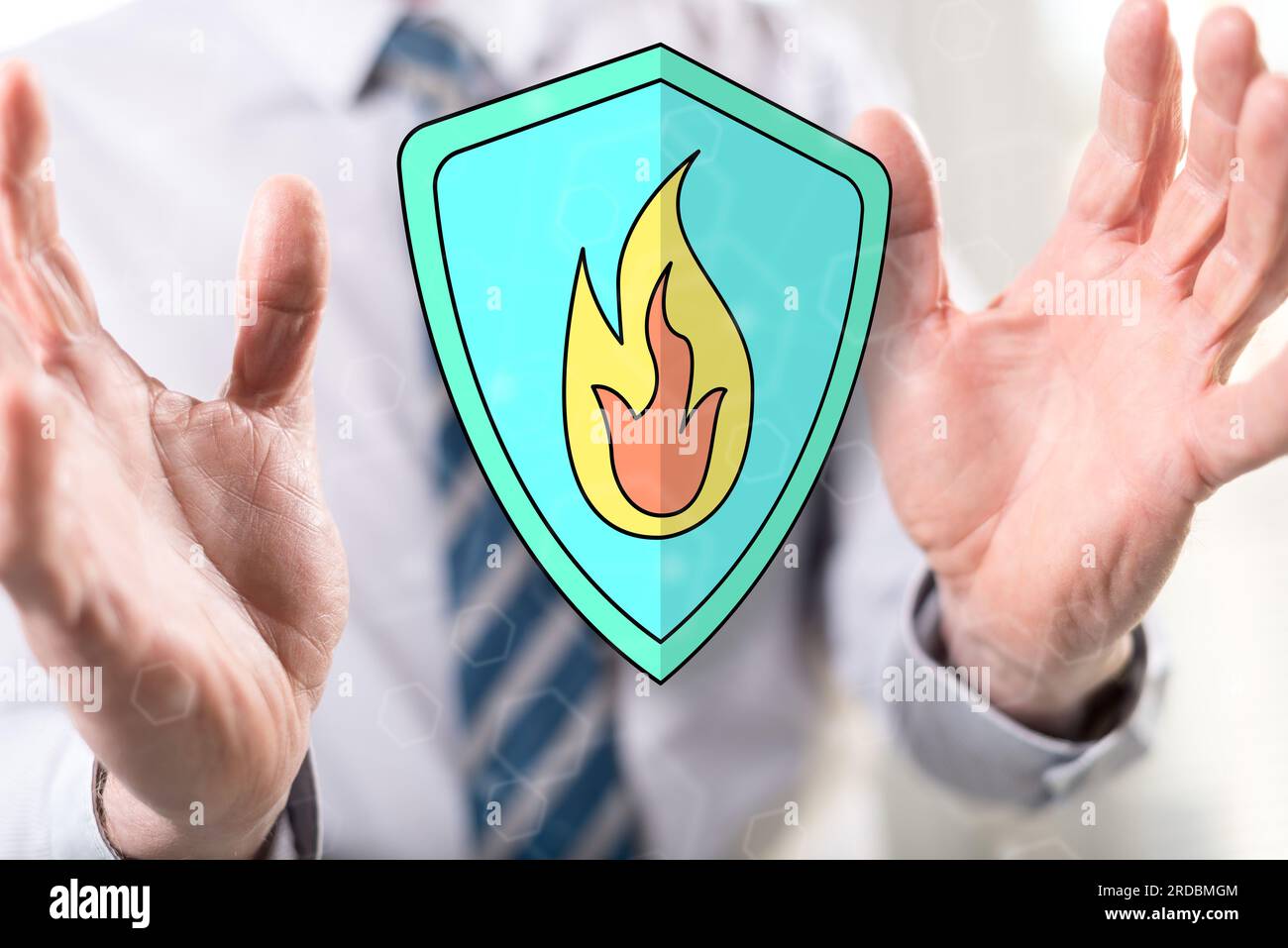 Fire protection concept between hands of a man in background Stock ...