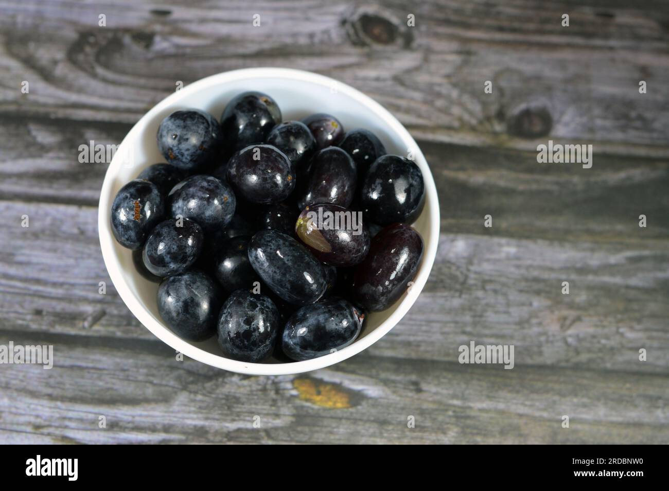 Black grapes, a fruit, botanically a berry of the deciduous woody vines ...