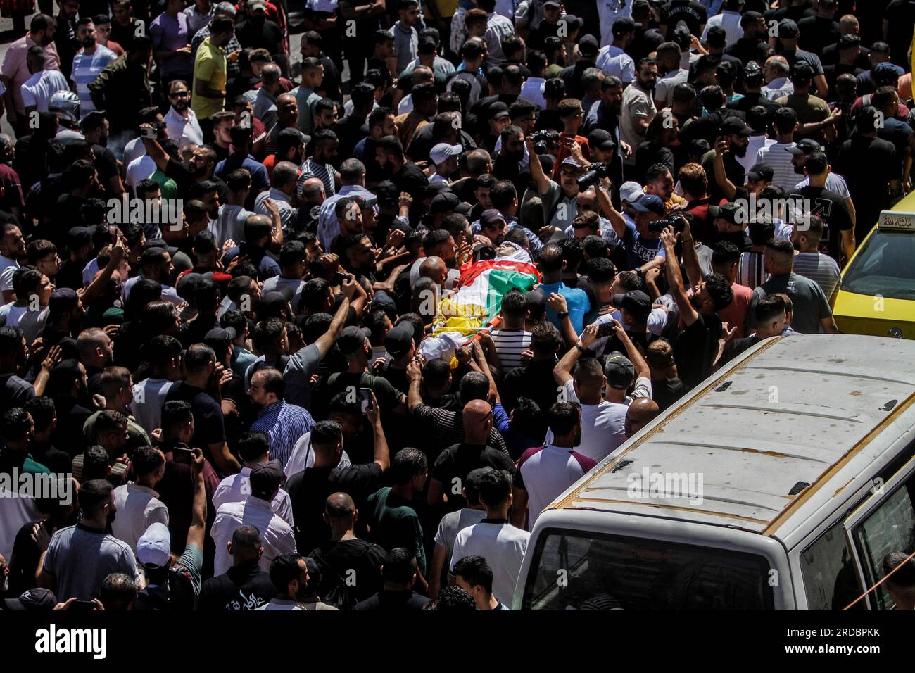 (EDITOR'S NOTE: Image depicts death) Mourners carry the body of ...