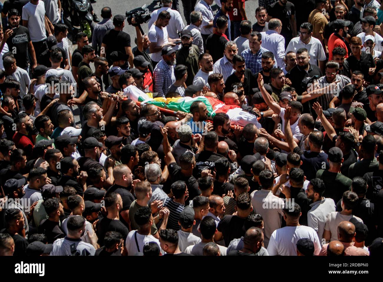 (EDITOR'S NOTE: Image depicts death) Mourners carry the body of ...