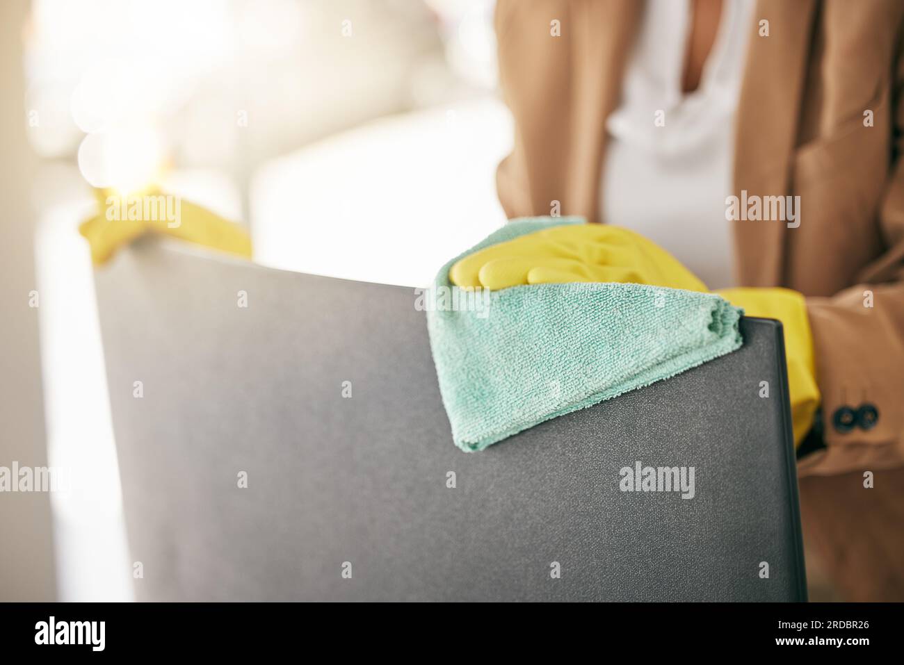 Woman, hands and cleaning chair with cloth for hygiene, bacteria or ...