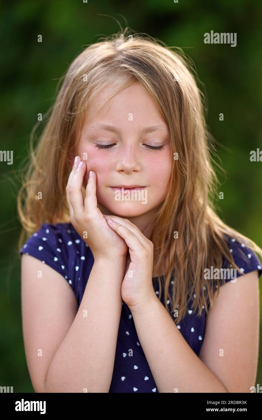 Portrait of a cute gentle girl with long hair and closed eyes Stock ...