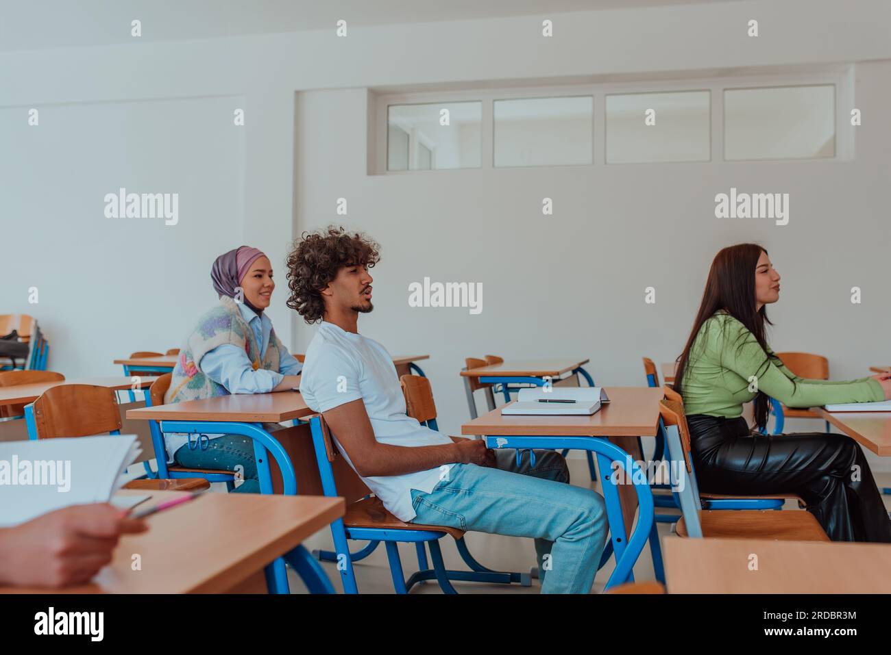 A diverse group of students is attentively listening, actively ... A diverse group of students is attentively listening, actively ...