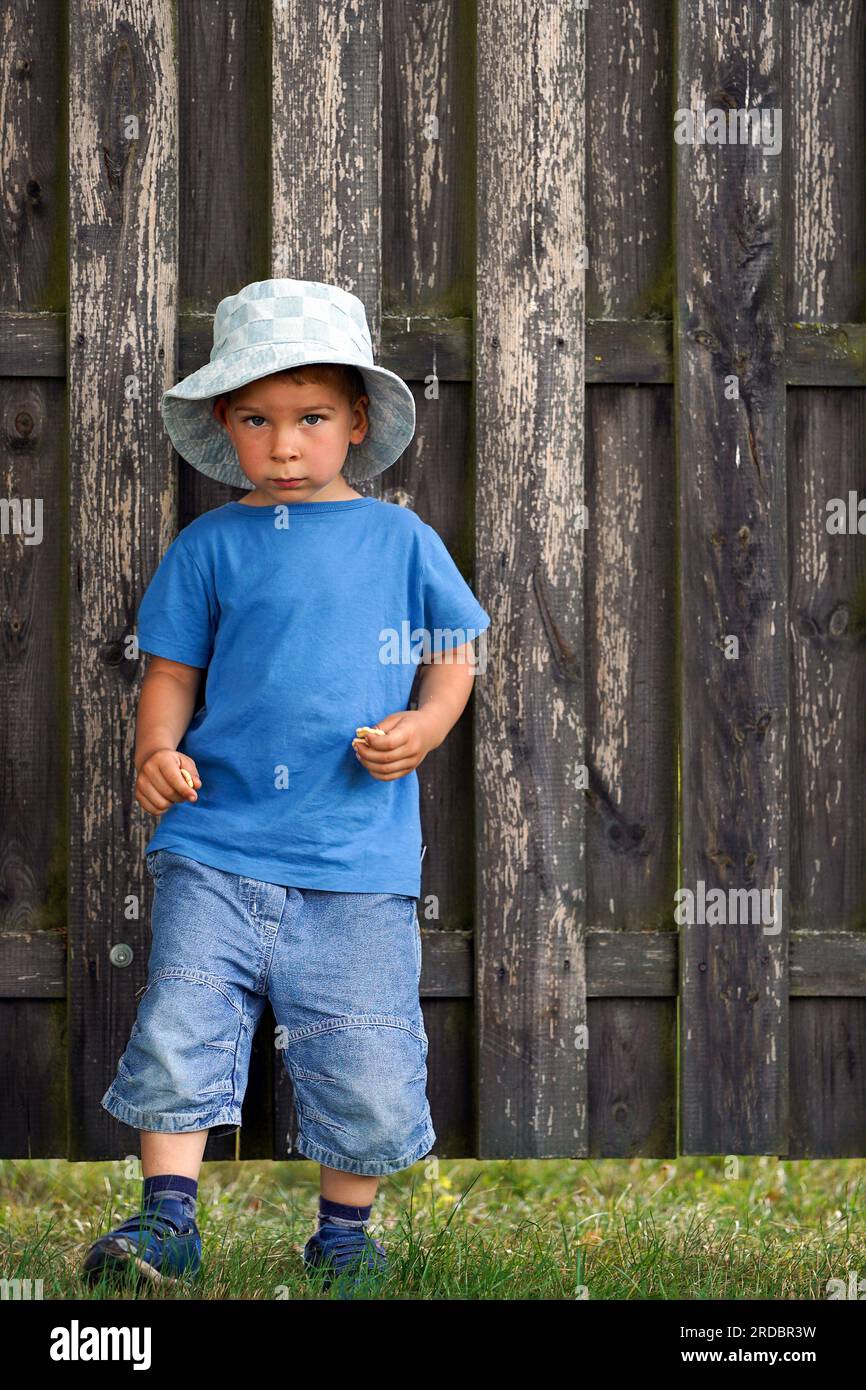 Cute boy in shorts, t-shirt and panama hat in the countryside Stock ...