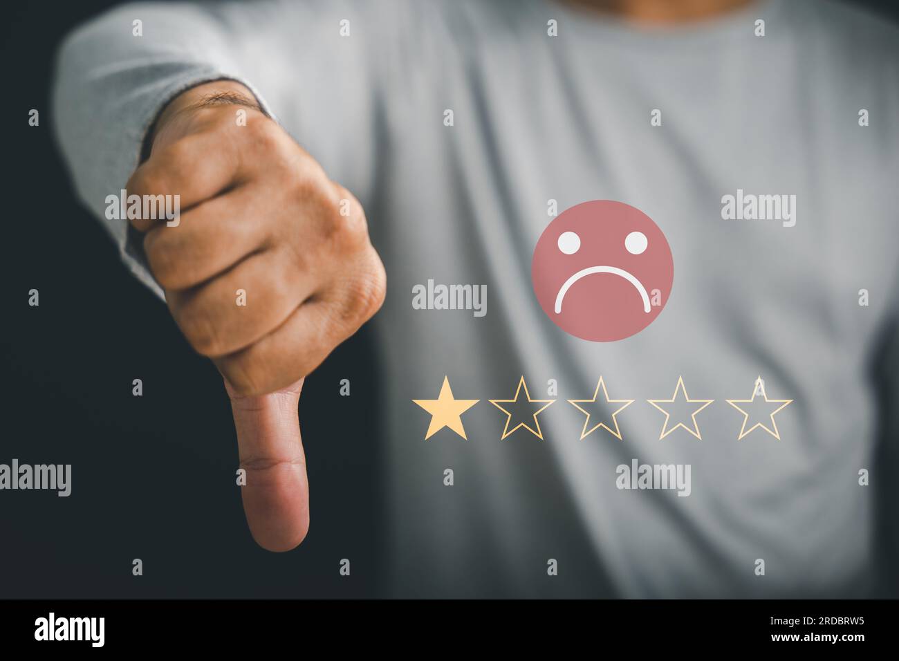 Hand showing a thumb down sign with a graphic one star Stock Photo - Alamy