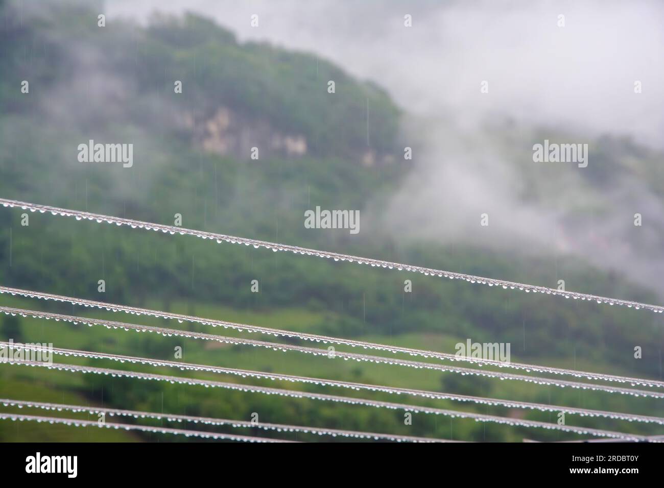 Series of clothes-hanging lines under the rain, with drops of water ...