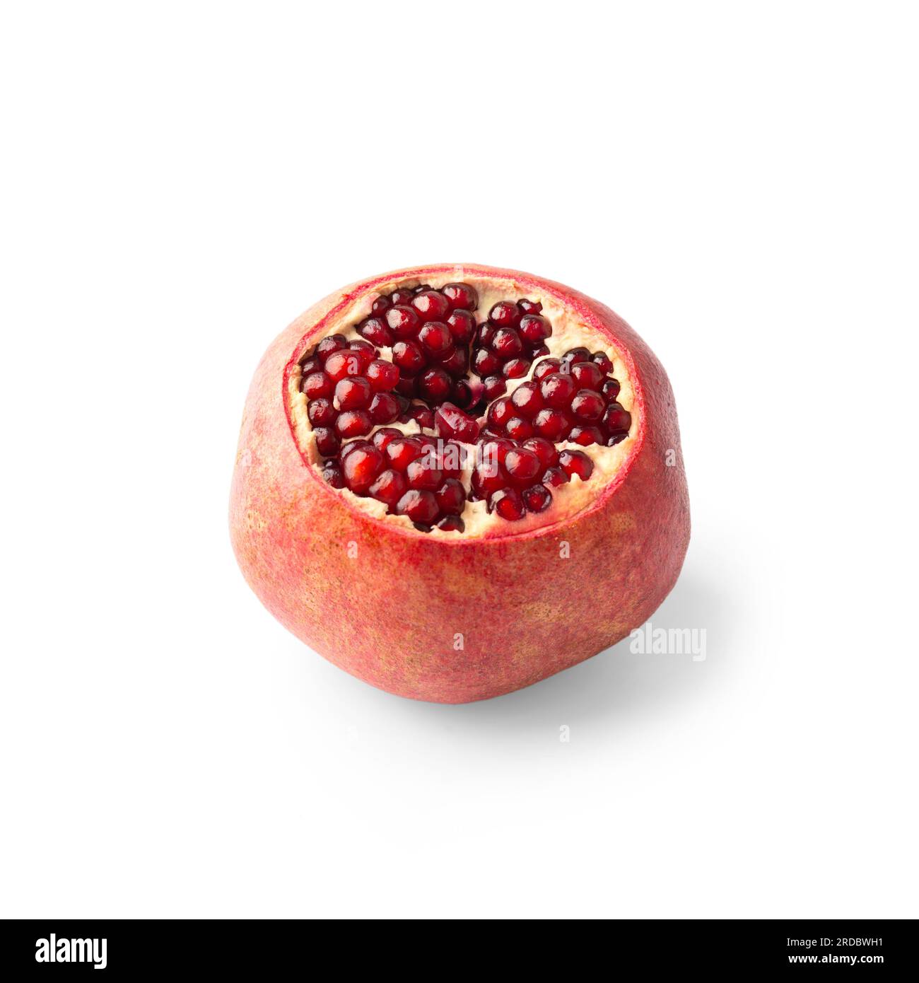 Ripe pomegranate fruit peeled on a white background top view close-up ...