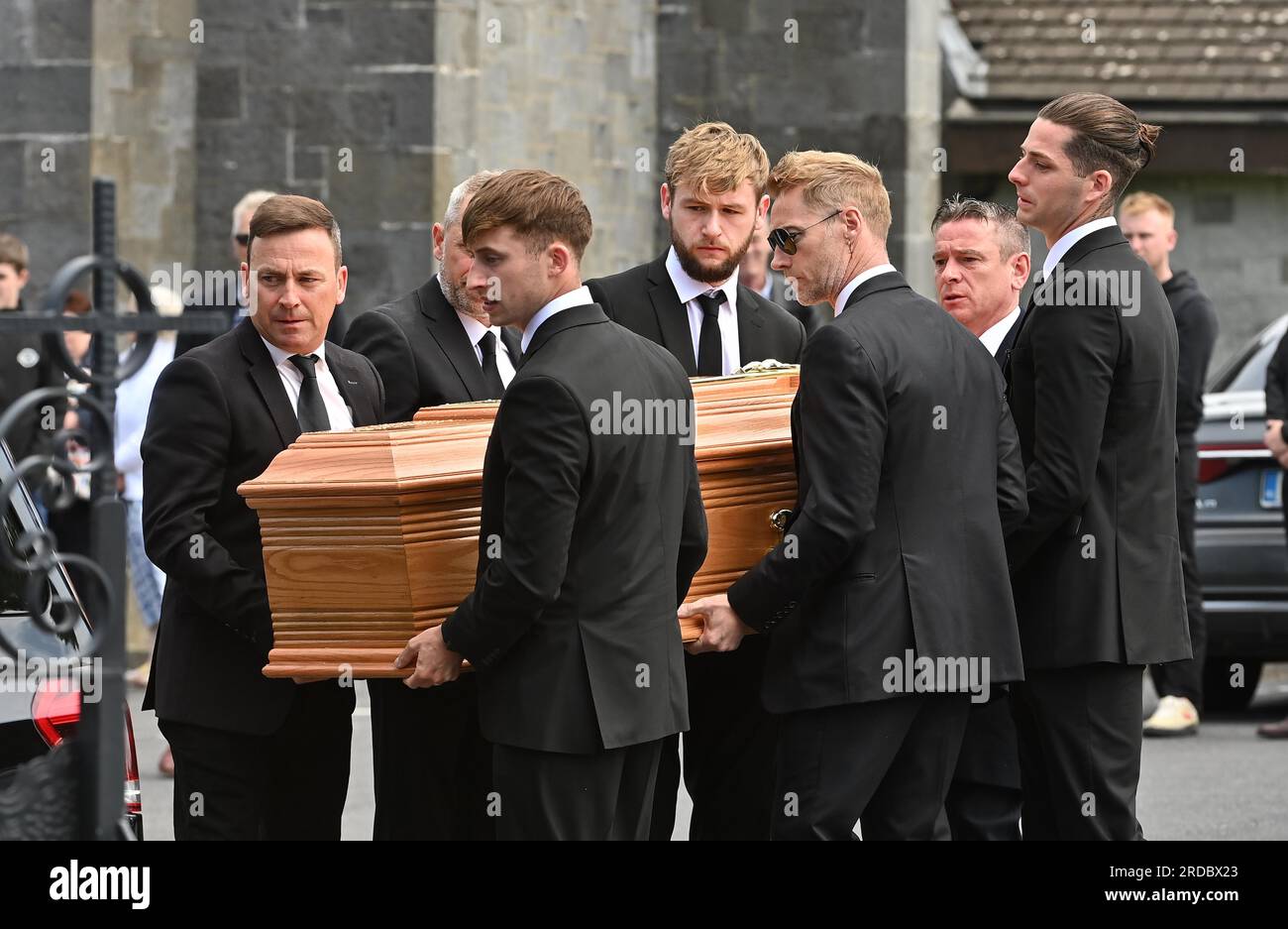 Ronan Keating (centre middle right) helps carry the coffin of his ...