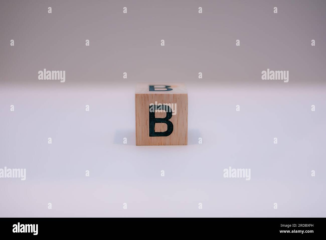 Wooden block written "B" with a white background Stock Photo - Alamy
