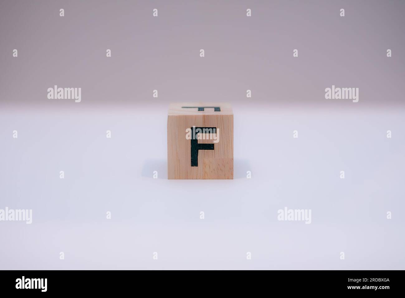Wooden block written "F" with a white background Stock Photo - Alamy