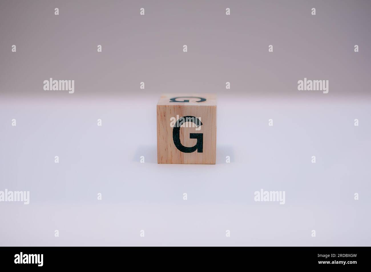 Wooden block written "G" with a white background Stock Photo - Alamy