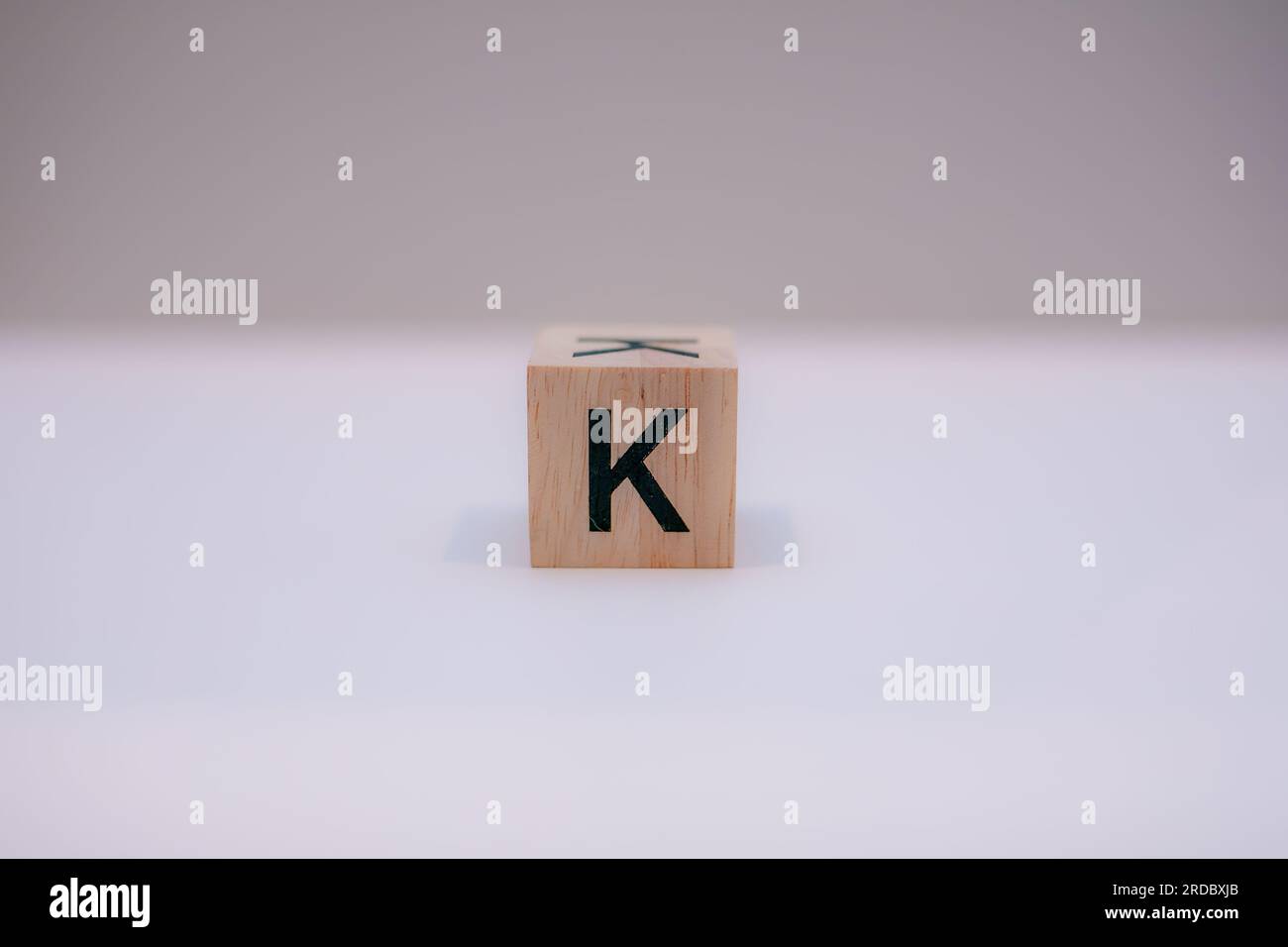 Wooden block written "K" with a white background Stock Photo - Alamy