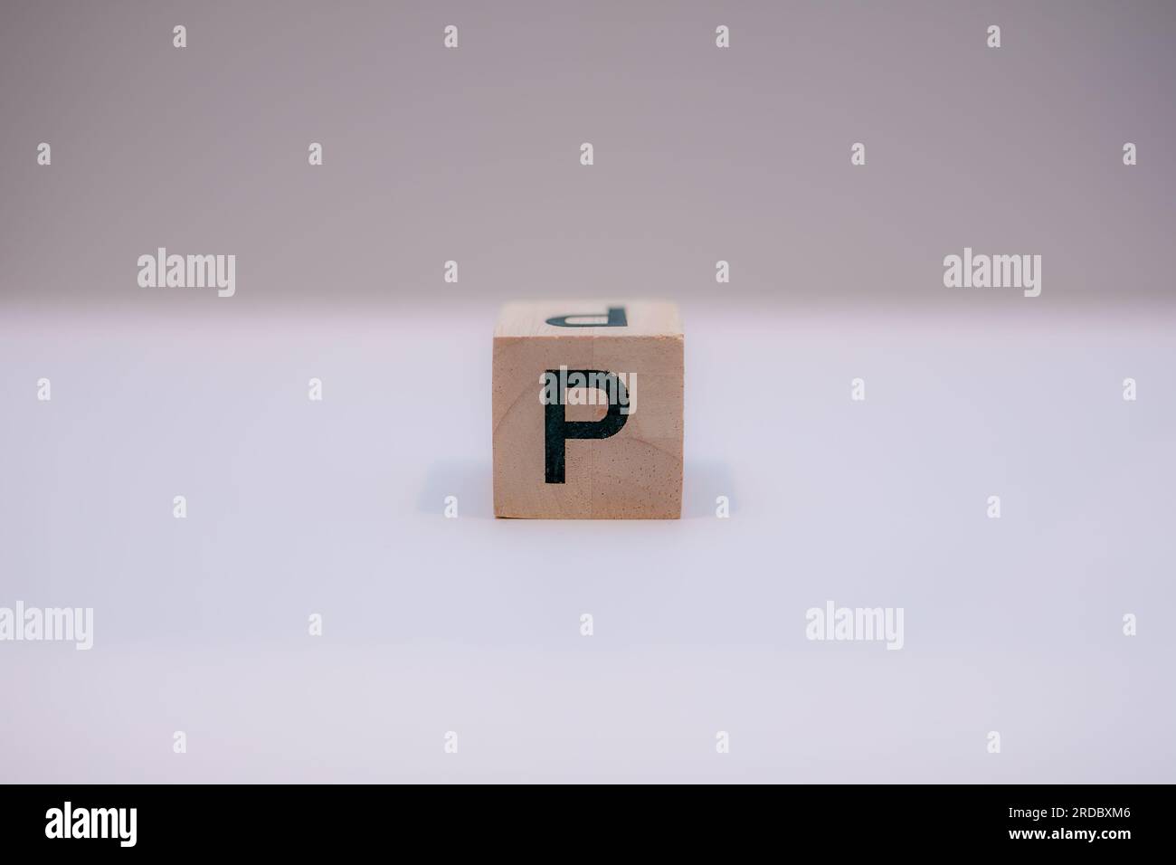 Wooden block written "P" with a white background Stock Photo - Alamy
