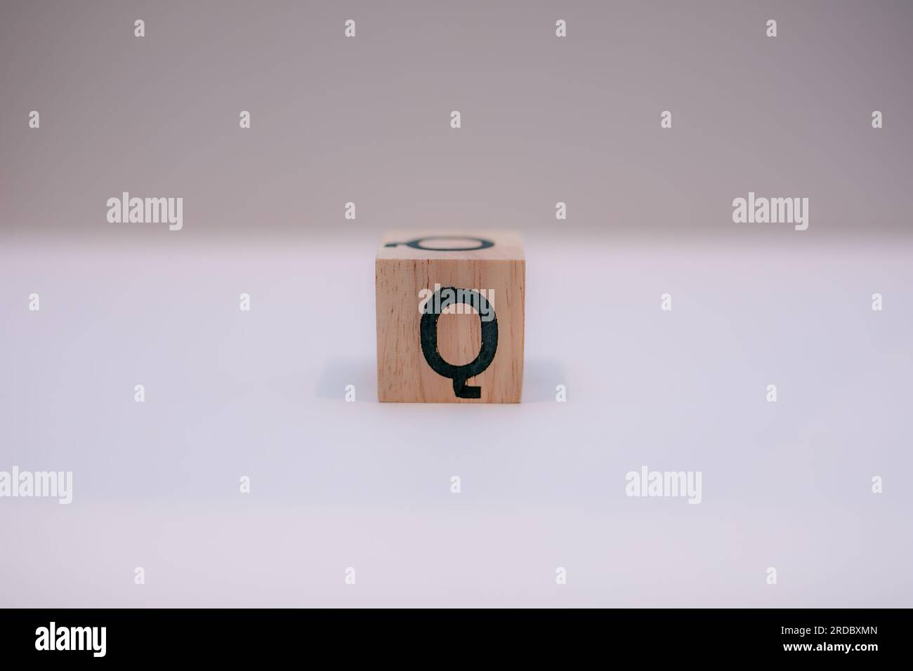 Wooden block written "Q" with a white background Stock Photo - Alamy
