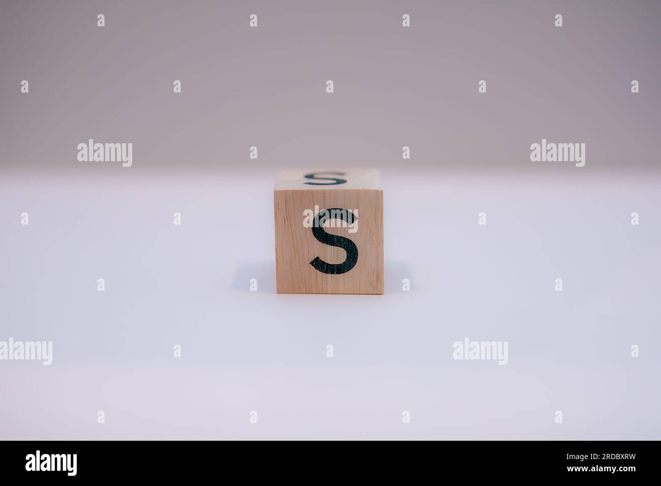 Wooden block written "S" with a white background Stock Photo - Alamy