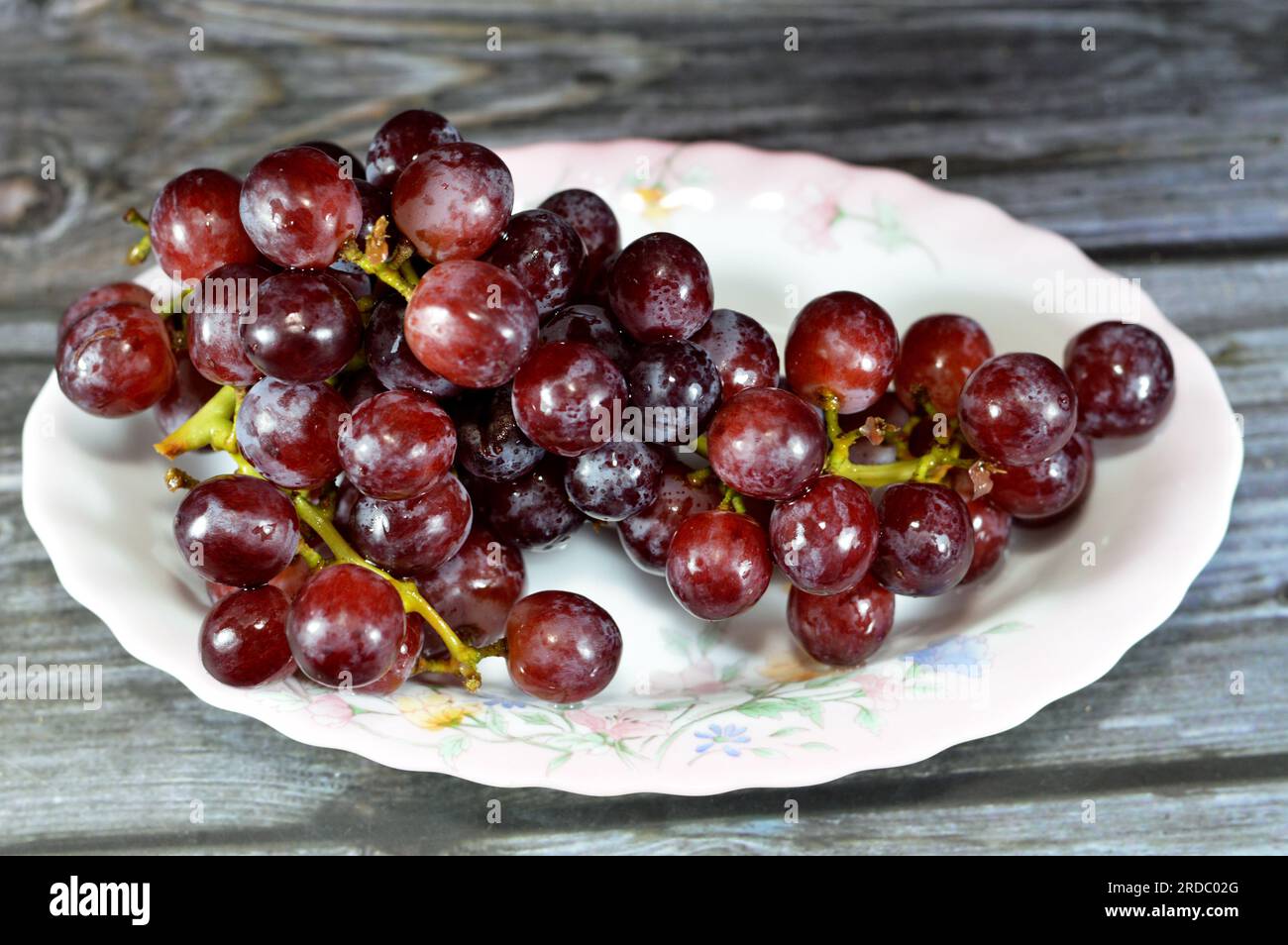 Red grapes, a fruit, botanically a berry of the deciduous woody vines ...