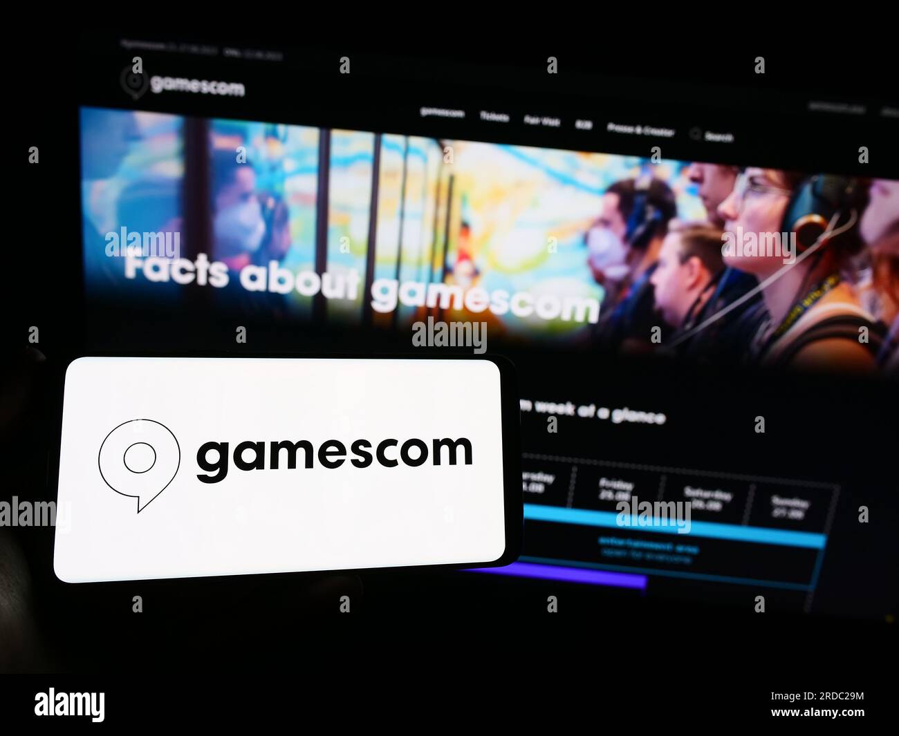 Person holding smartphone with logo of German video game trade fair ...