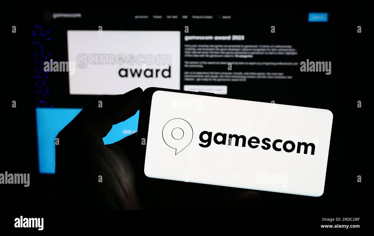 Person holding cellphone with logo of German video game trade fair ...