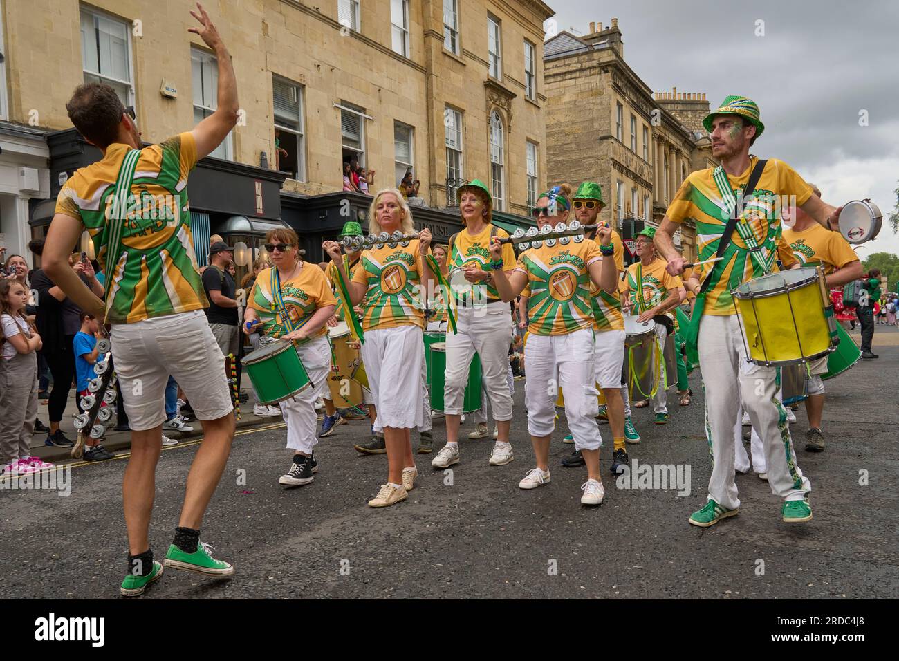 Dancers and musicians dressed in ornate costumes parade through the ...