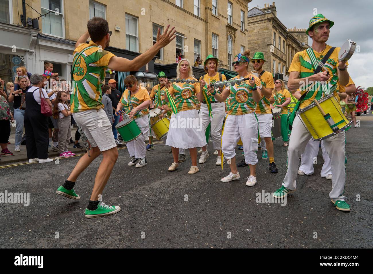 Dancers and musicians dressed in ornate costumes parade through the ...