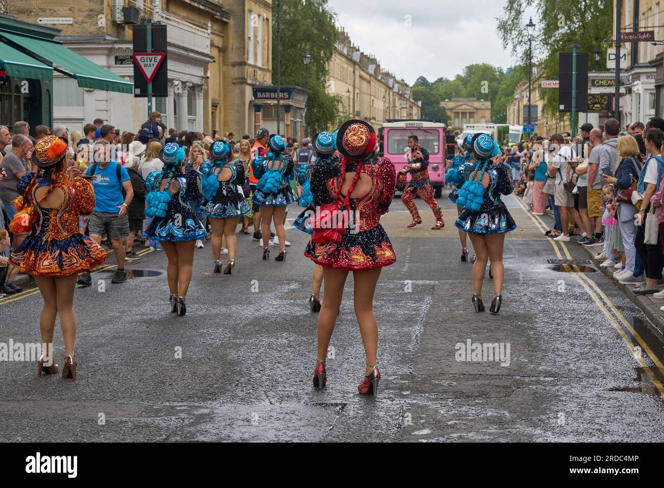 Dancers and musicians dressed in ornate costumes parade through the ...