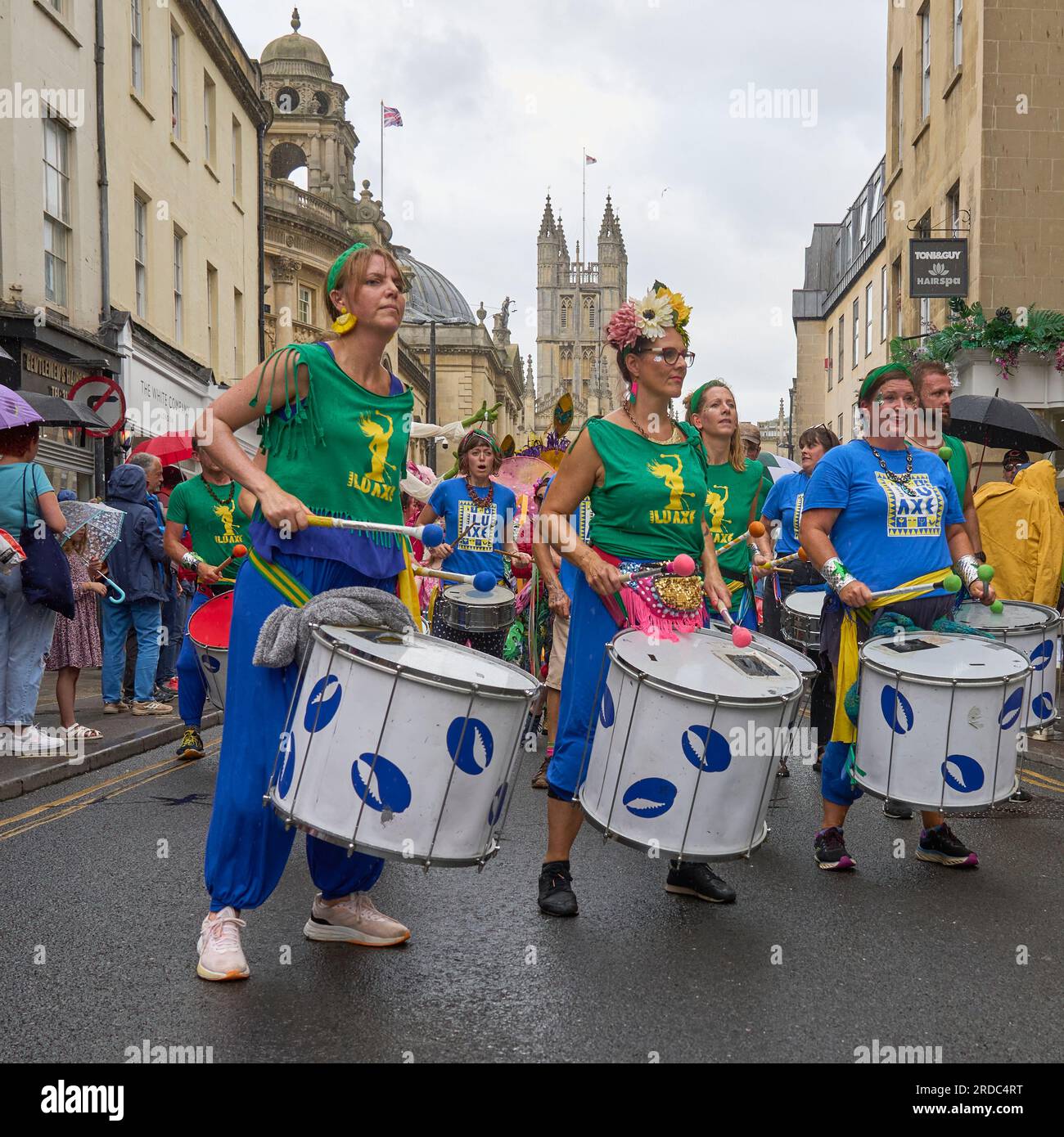 Dancers and musicians dressed in ornate costumes parade through the ...