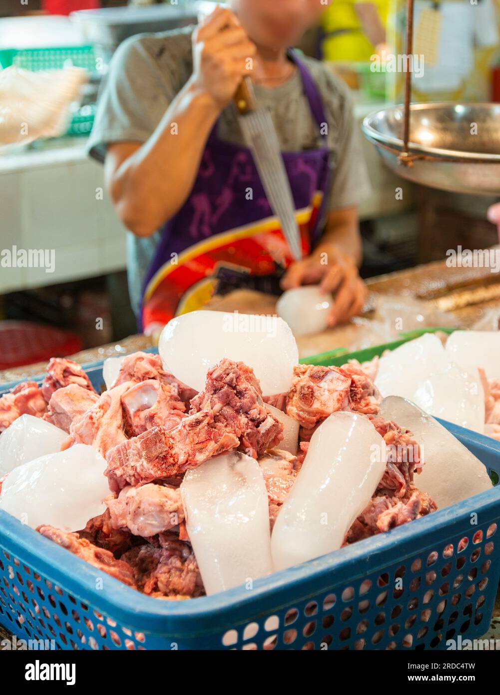 Using the sharp pointed end of a meat cutting blade,the man breaks the ...