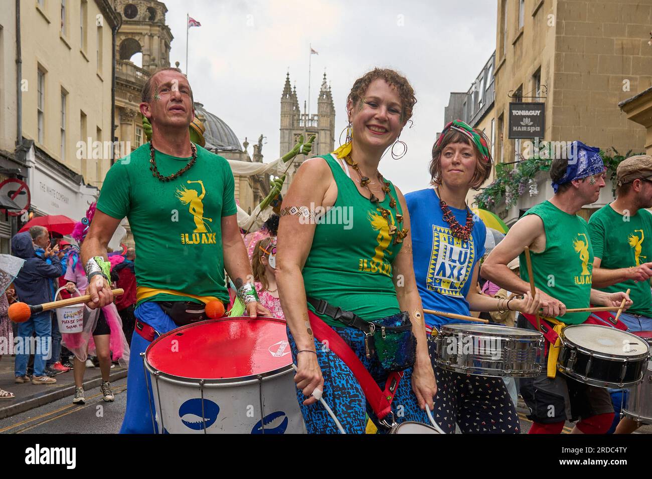 Dancers and musicians dressed in ornate costumes parade through the ...