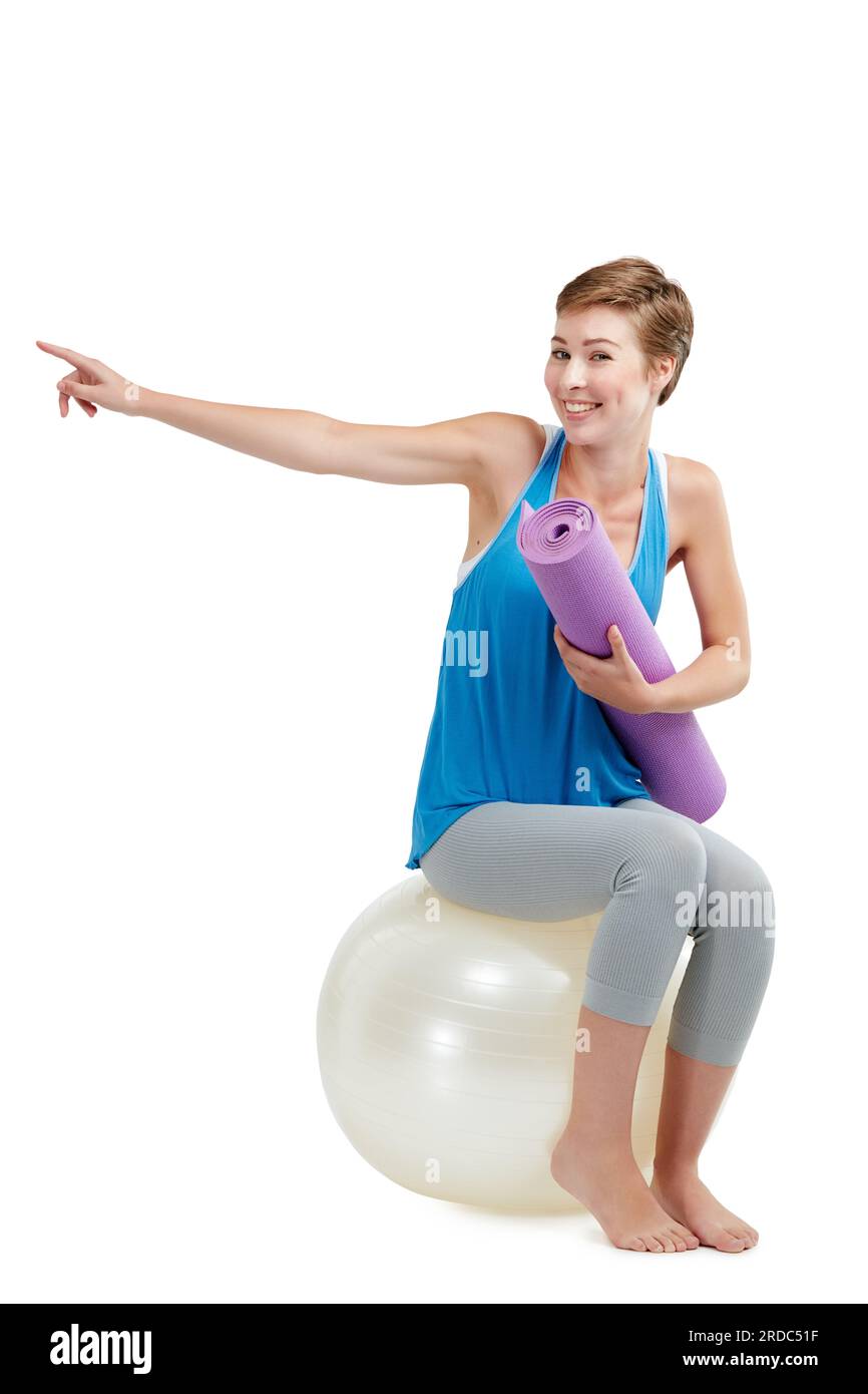 Pilates, pointing and woman isolated on a white background with balance ...