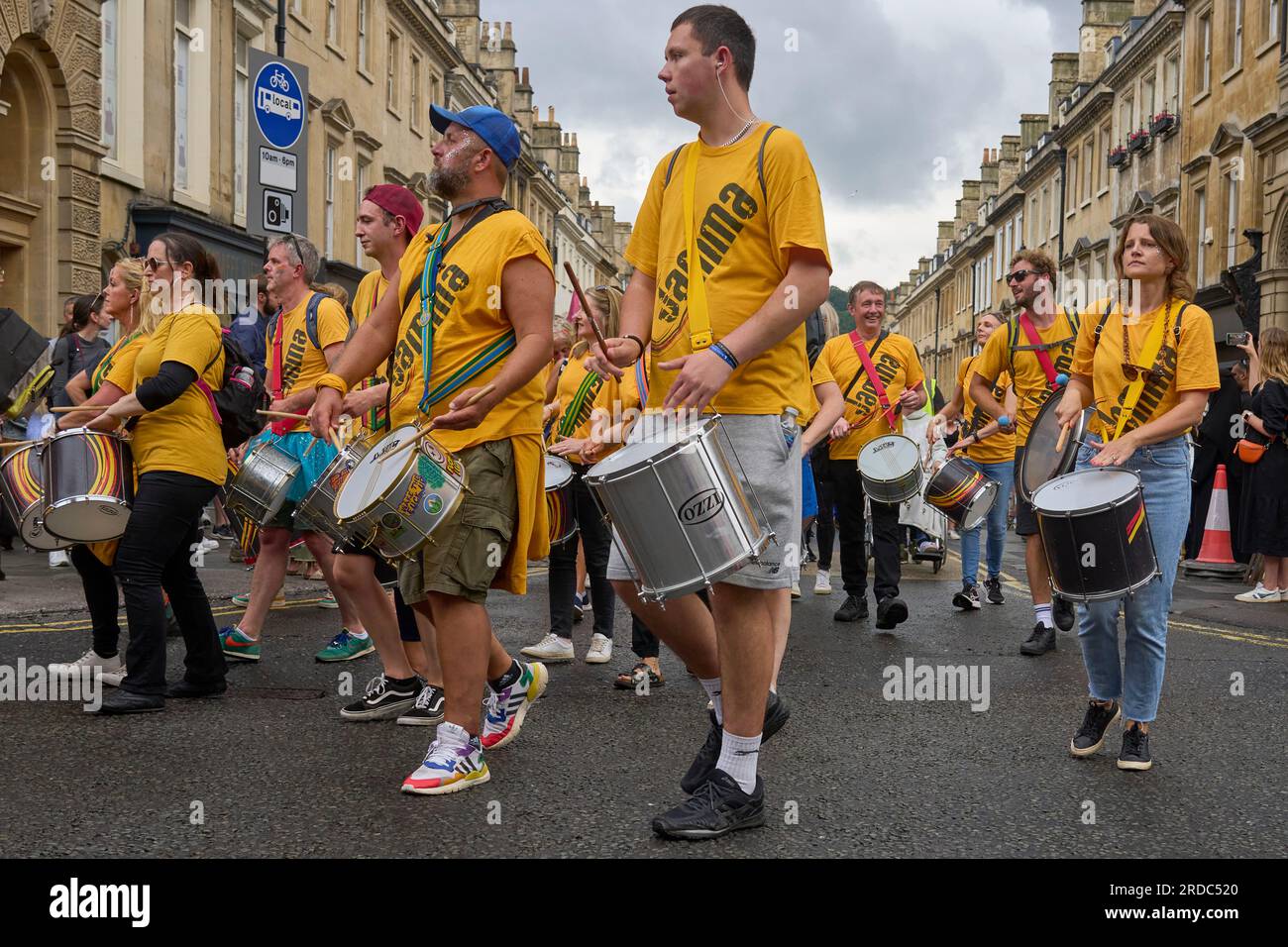 Dancers and musicians dressed in ornate costumes parade through the ...
