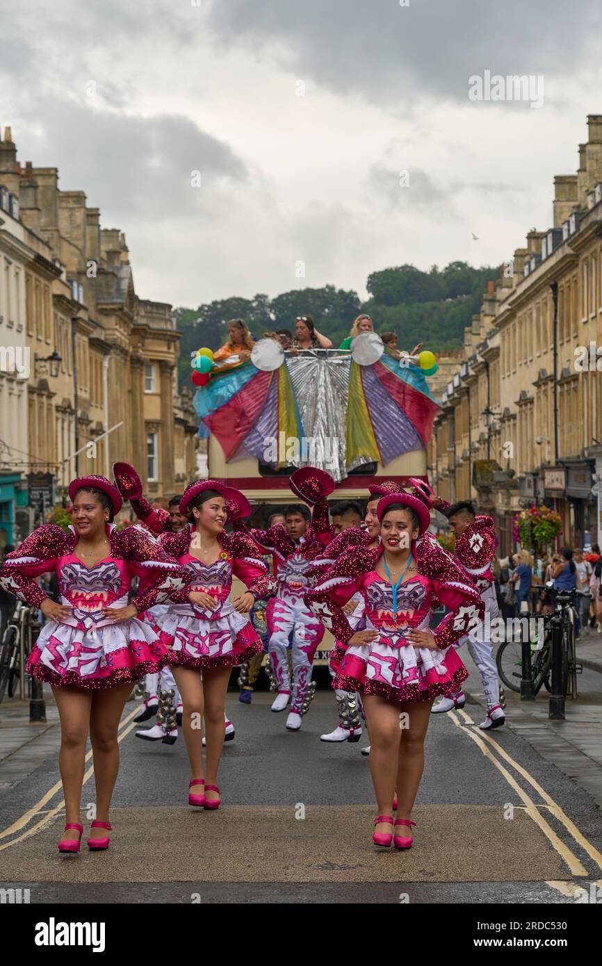 Dancers and musicians dressed in ornate costumes parade through the ...
