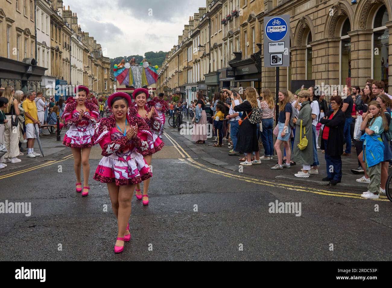 Dancers and musicians dressed in ornate costumes parade through the ...